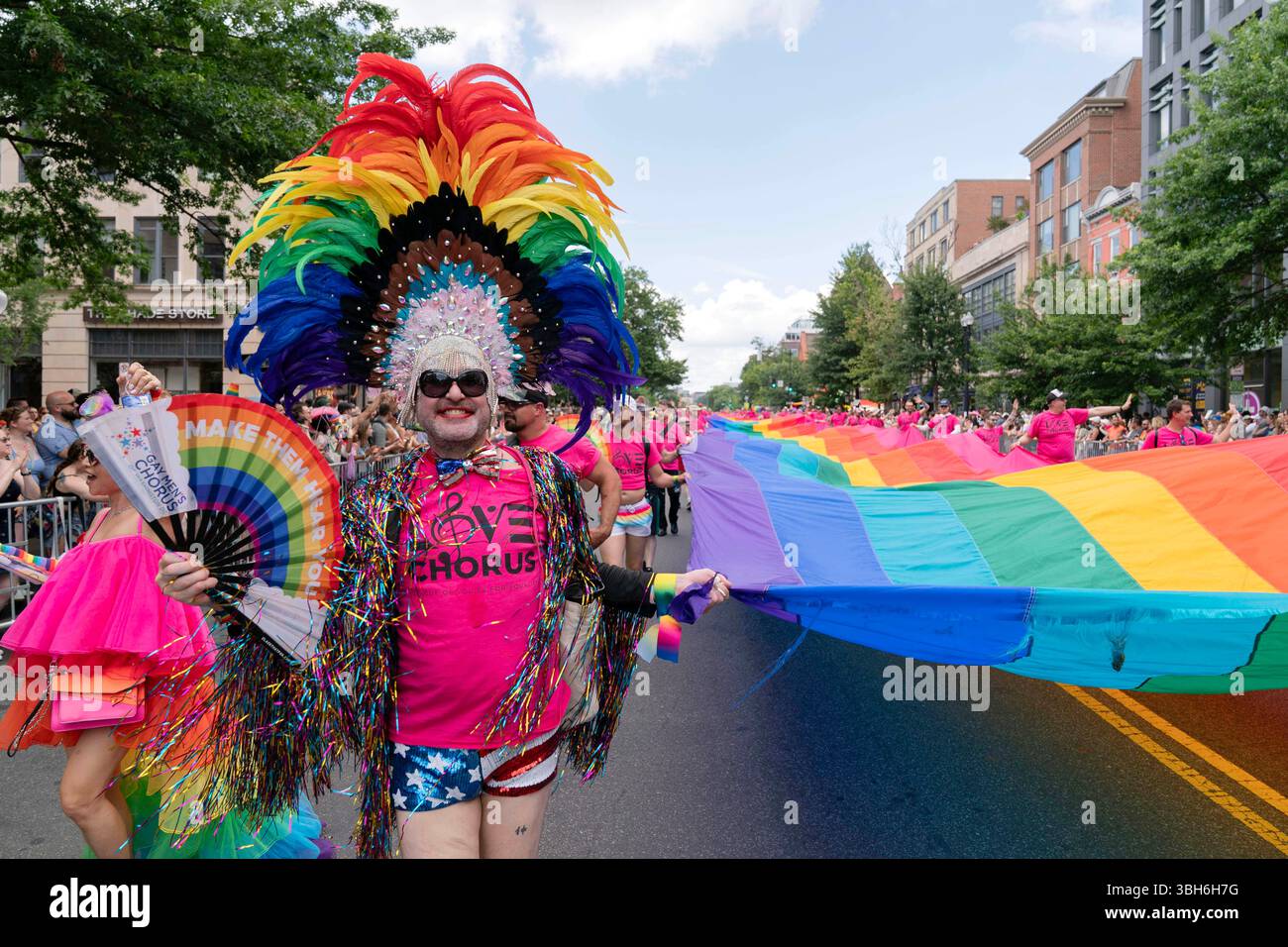 People carry a large pride flag as they march during the World Pride ...