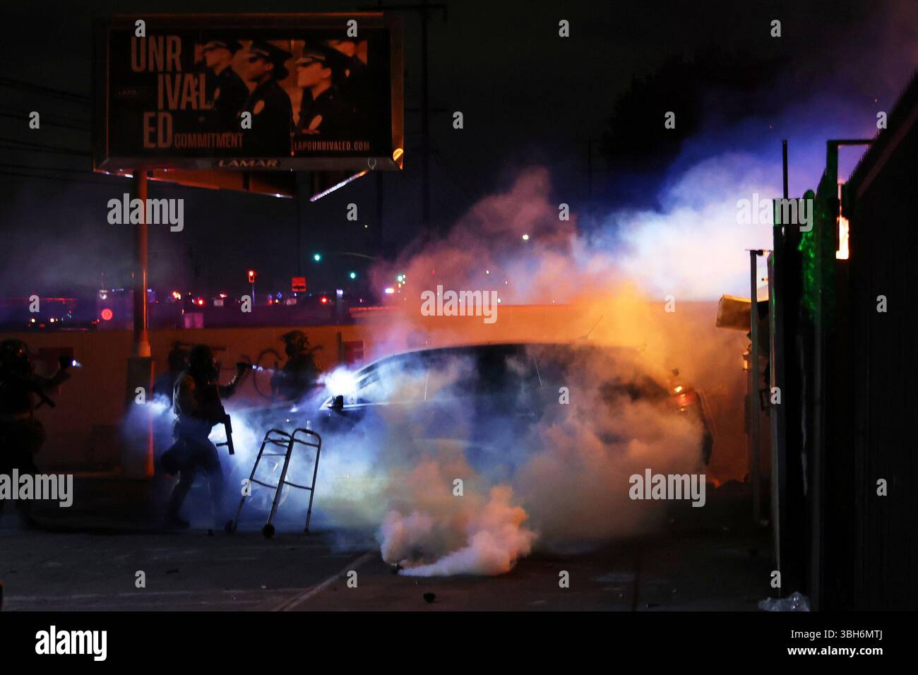 Law enforcement investigate a car with a person inside during a protest ...