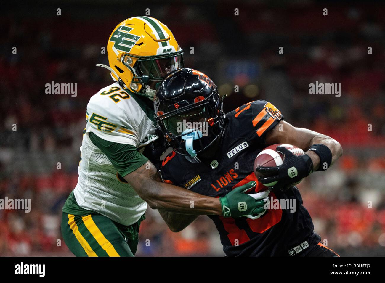 Edmonton Elks' Leonard Johnson (32) stops B.C. Lions' Jermaine Jackson ...