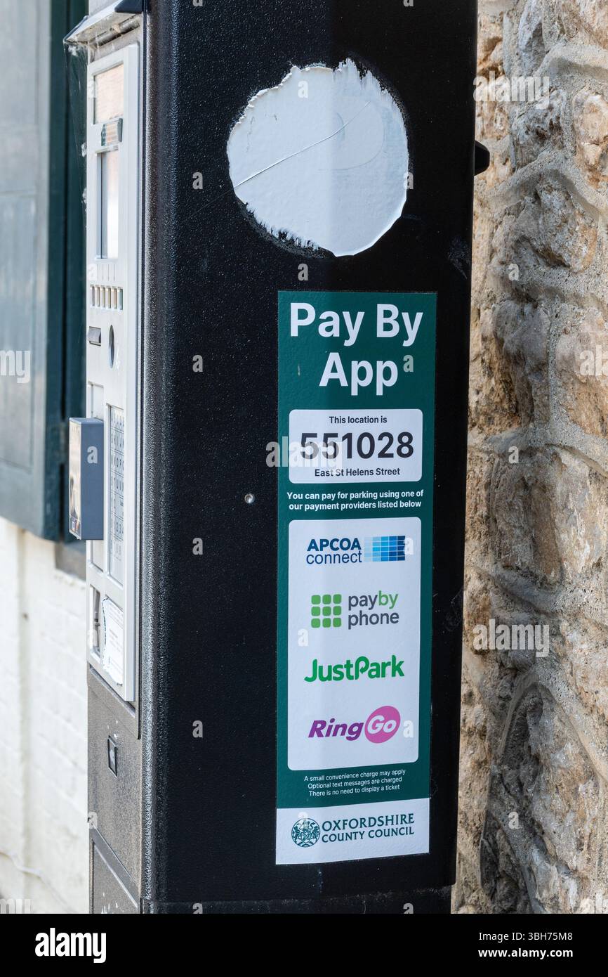Parking meter in street with various Pay by App options, including ...