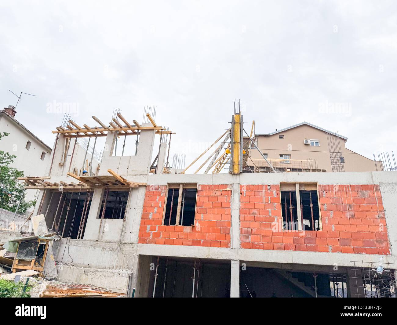 Concrete and brick building under active construction. Framework ...
