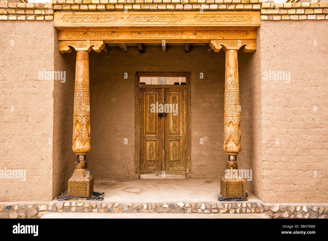 Entrance of a traditional house featuring intricately carved wooden ...