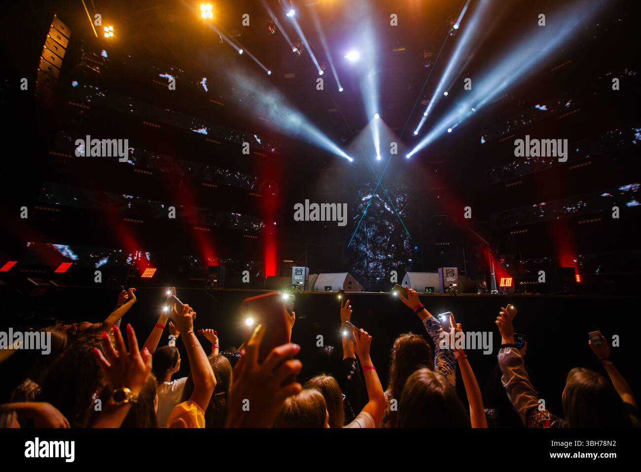 Pop Concert Audience with Raised Hands and Stage Lights Stock Photo - Alamy