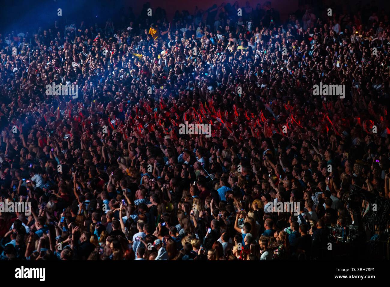 Large Audience at a Concert with Raised Hands and Mobile Phones Stock ...