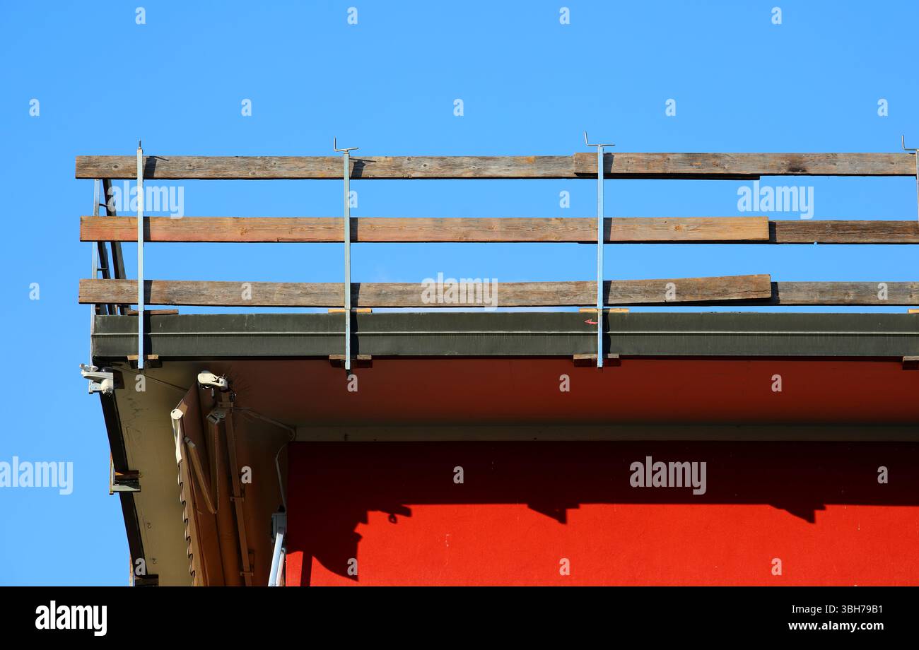 fall protection barrier with wooden planks marks the work area on the ...