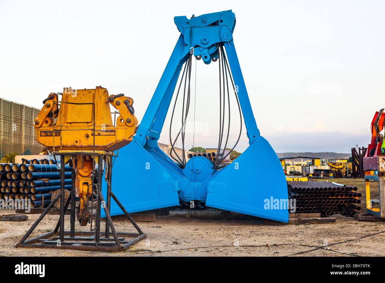 The territory of the seaport. Bundled steel pipes, a large harbor crane ...