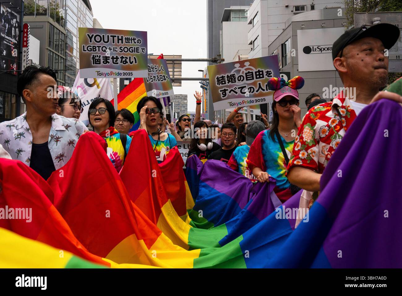 People carry a pride flag as they take part in the Pride March in Tokyo ...