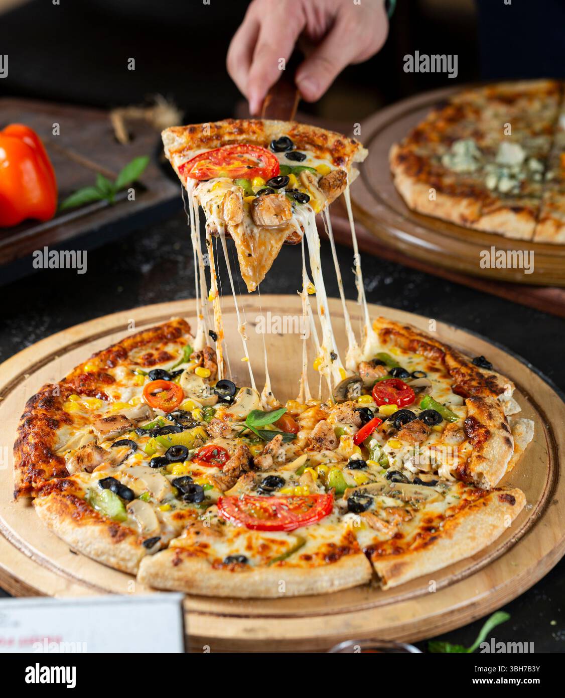 Stretching melted cheese on authentic Italian pizza Stock Photo - Alamy