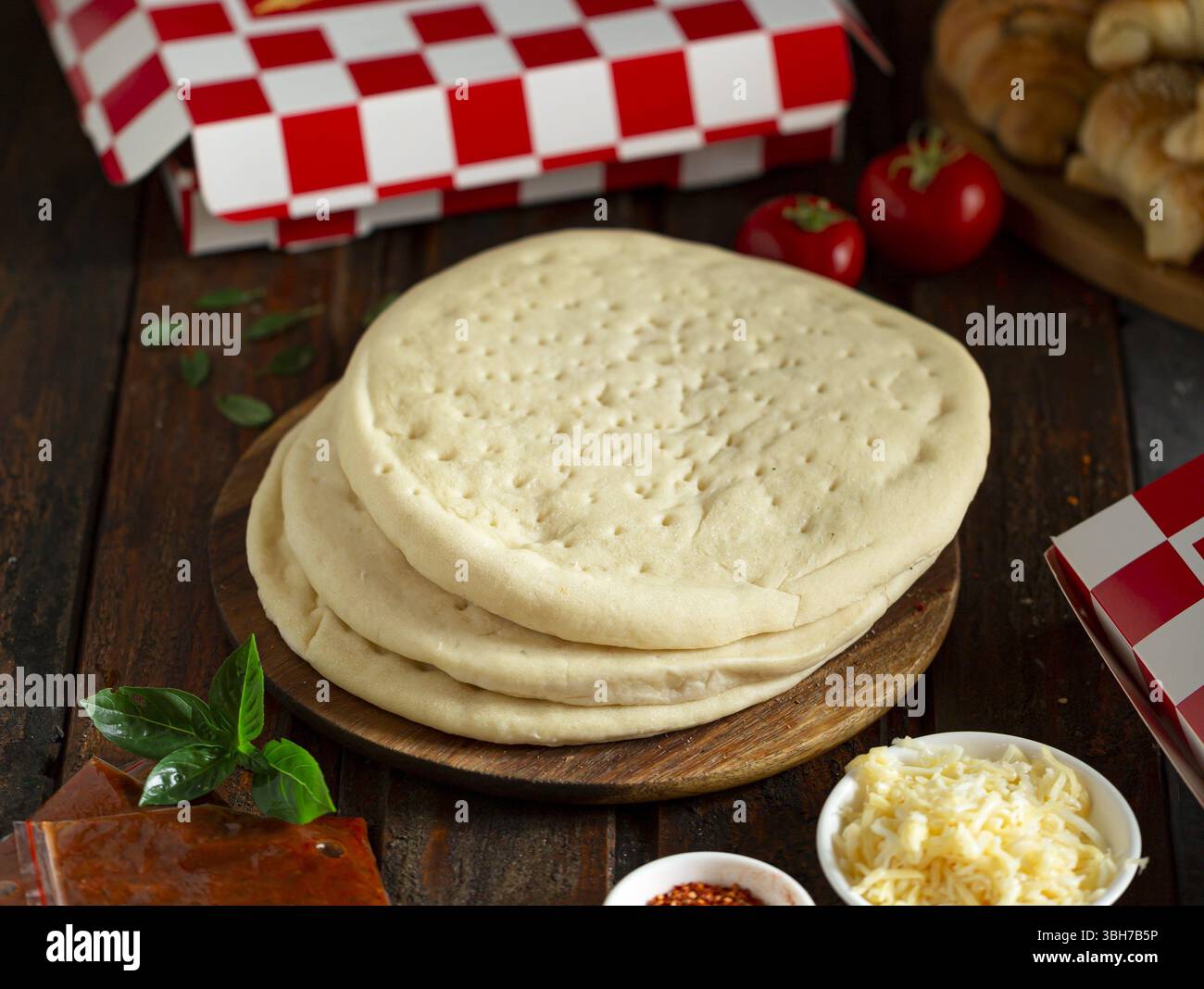 Half-baked pizza dough ready for assembling pizza Stock Photo - Alamy