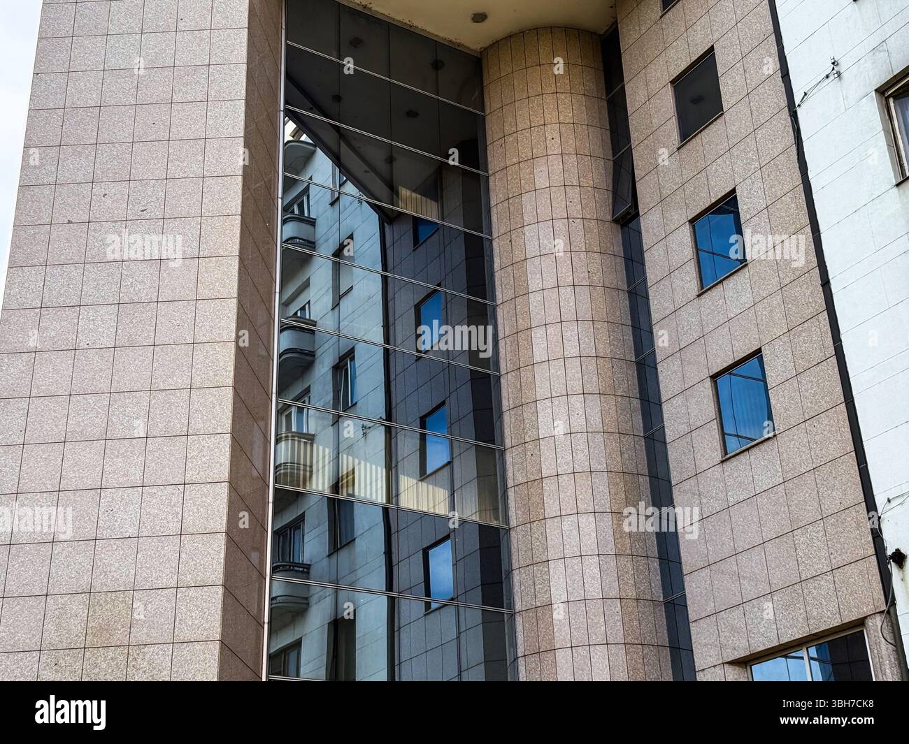 Glass facade reflecting residential architecture in urban environment ...
