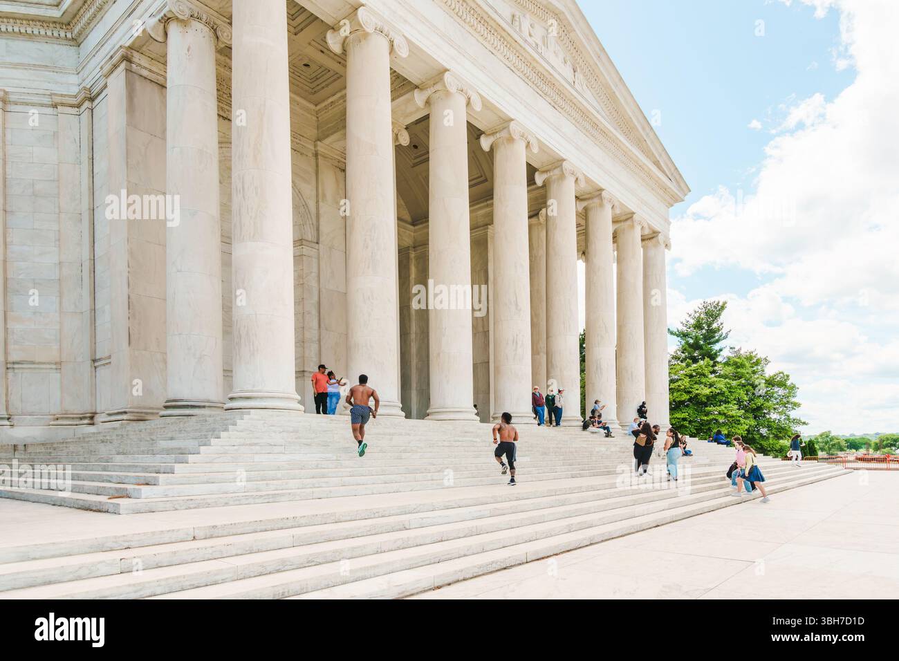 Washington D.C., USA, - May 24, 2025. Visitors and joggers share the ...