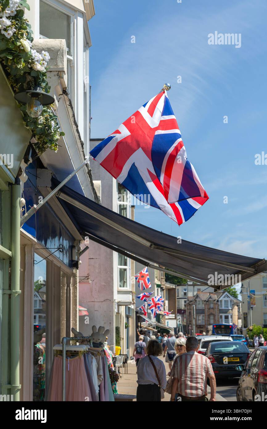 Union Jack flags on shops in street of historic buildings, The Strand ...