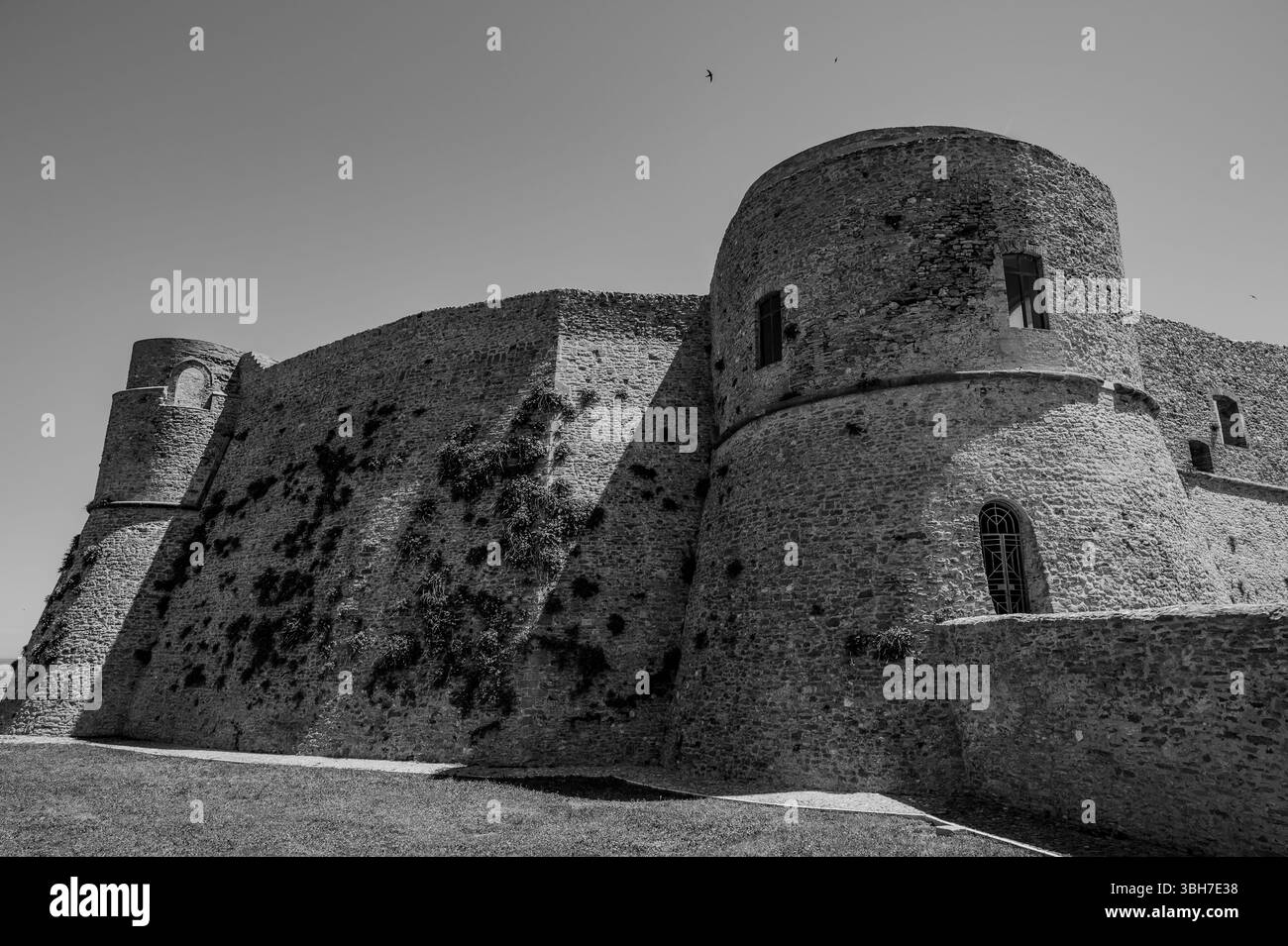 View of castle fortification wall with green grass and garden Black and ...