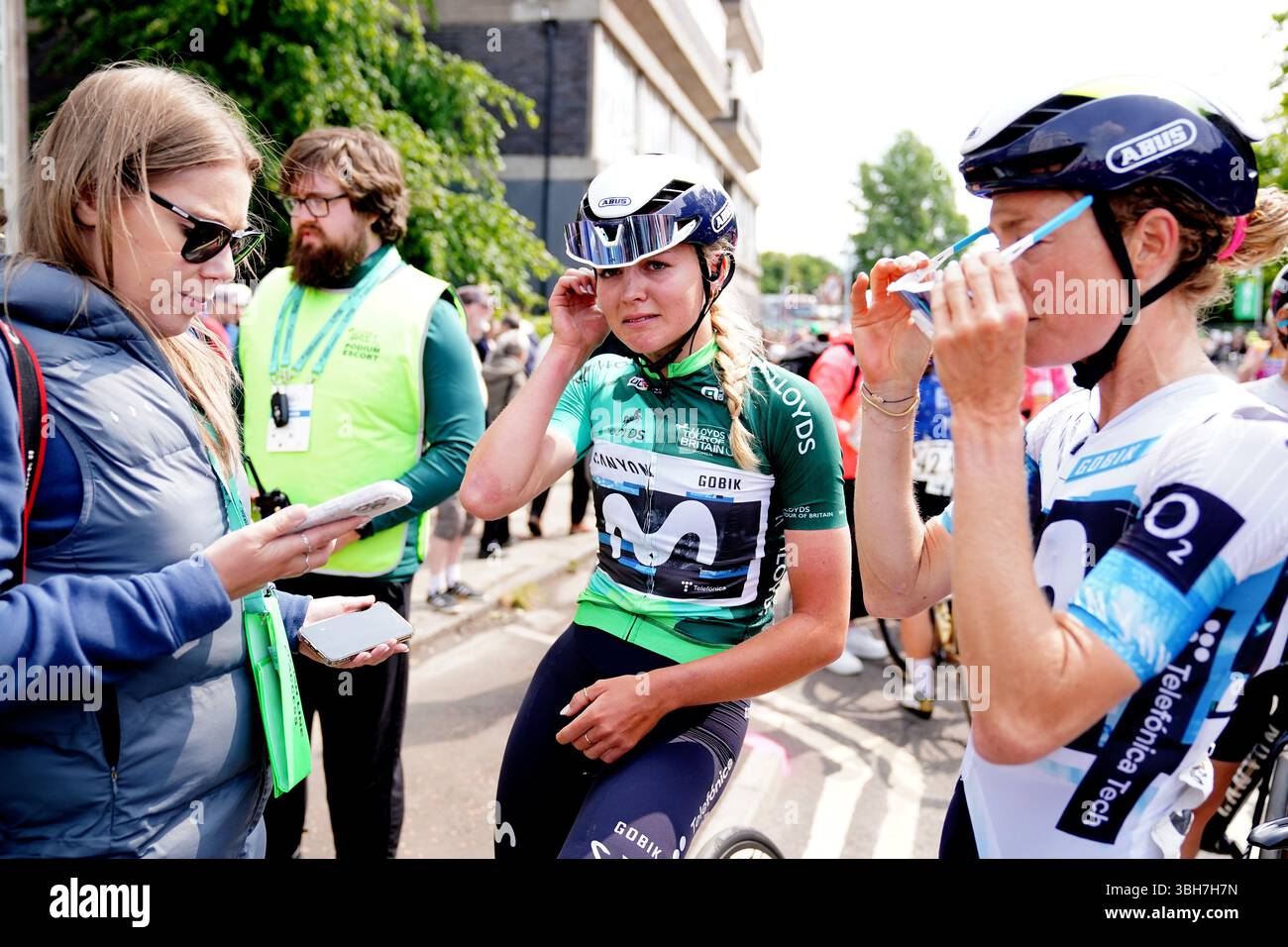 Cat Ferguson of Movistar Team (centre) reacts after finishing second ...