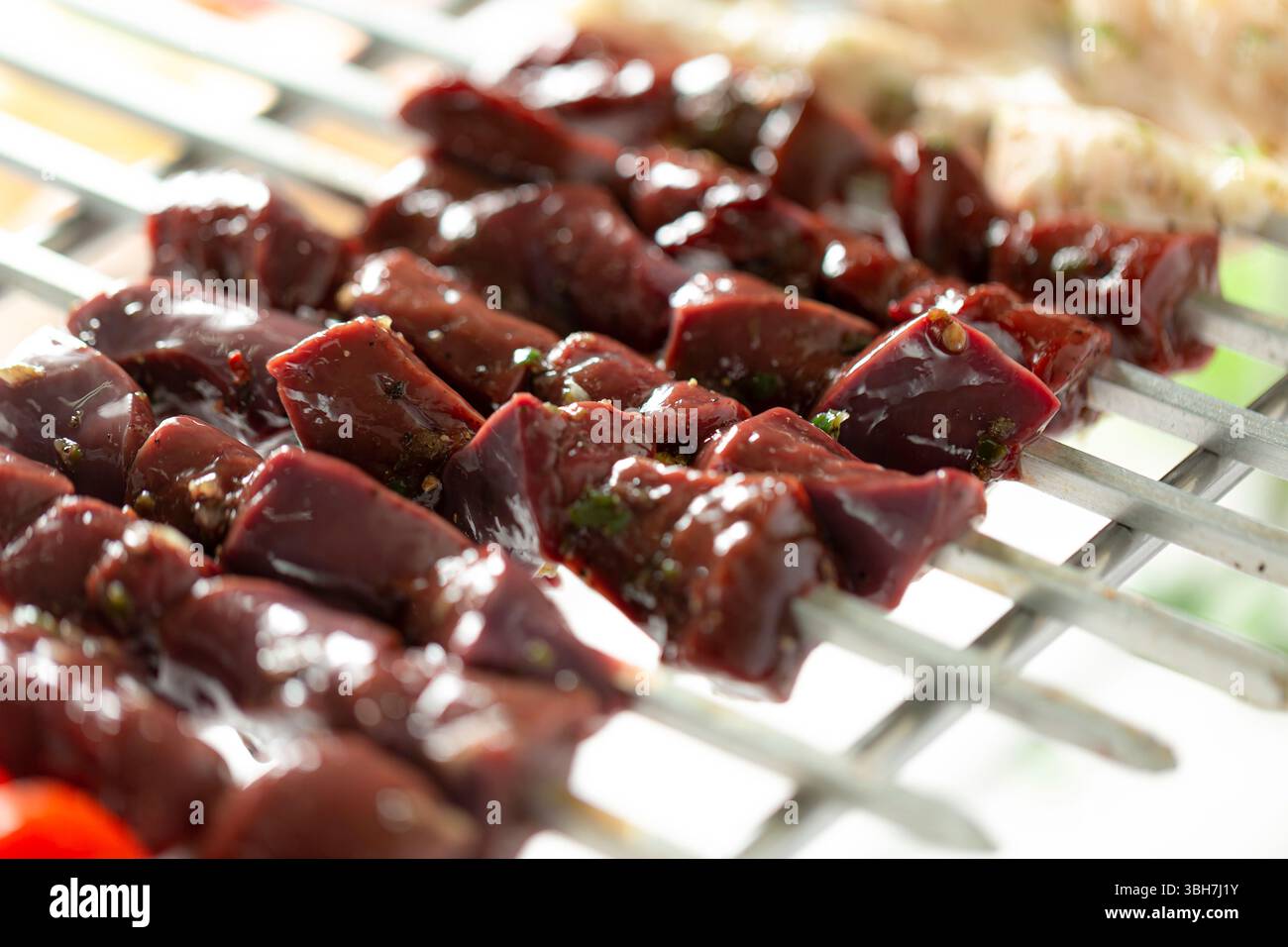 Raw veal liver on skewers, ready for grilling, white background Stock ...