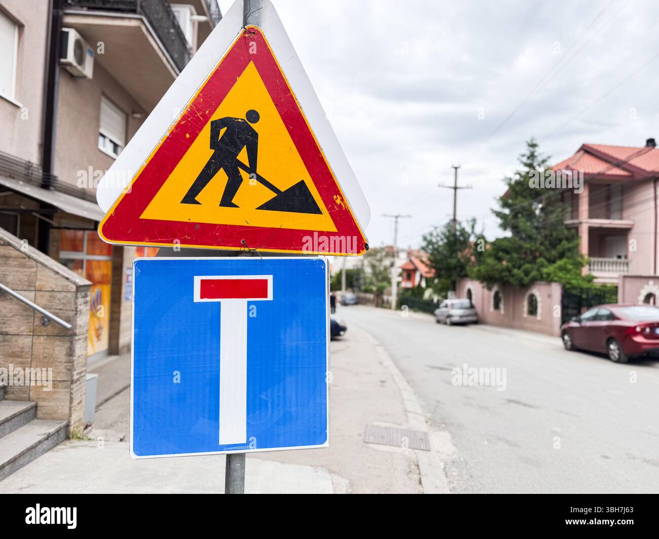Road signs on quiet residential street. Urban safety, traffic control ...