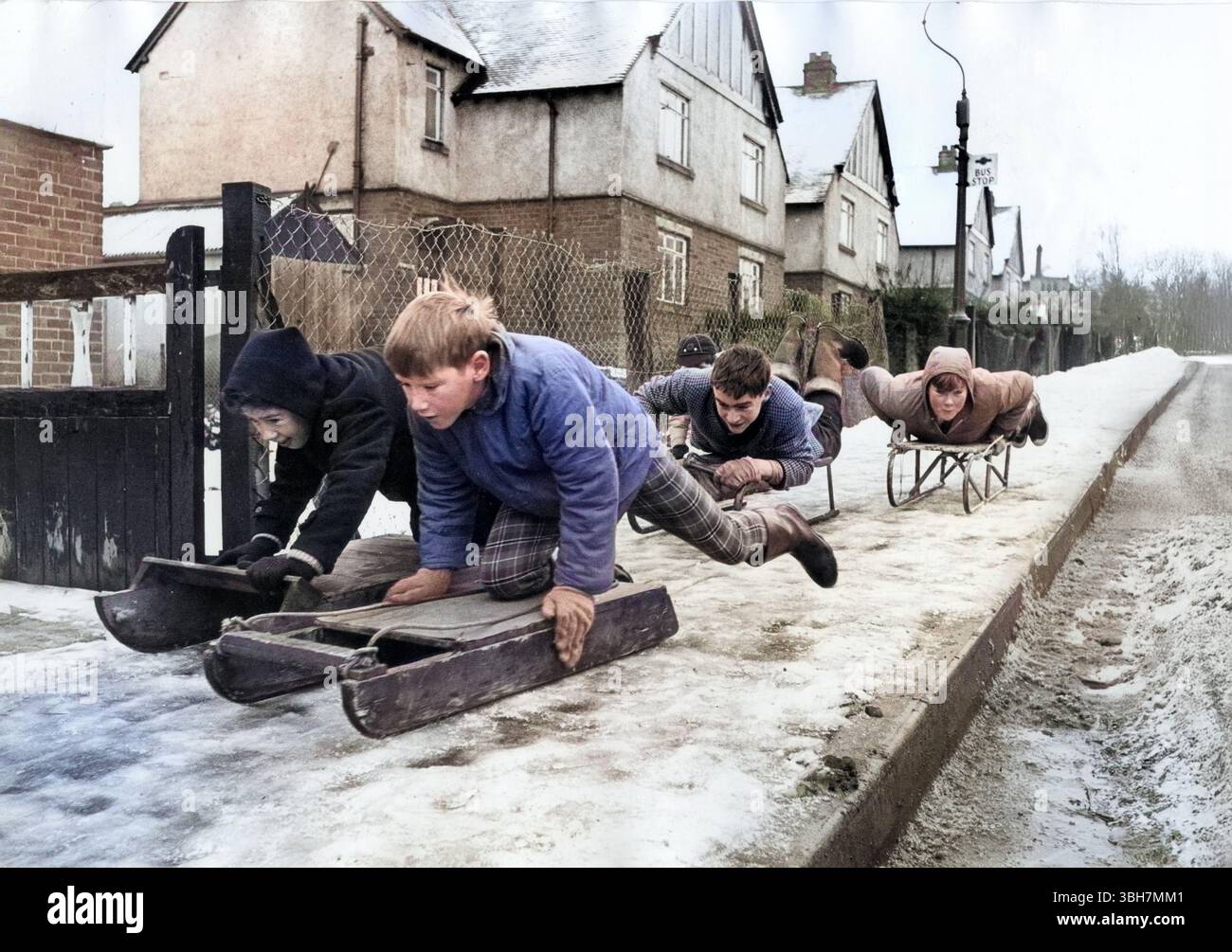 Boys children sledging on pavement Bridgnorth Shropshire Britain 1964 ...