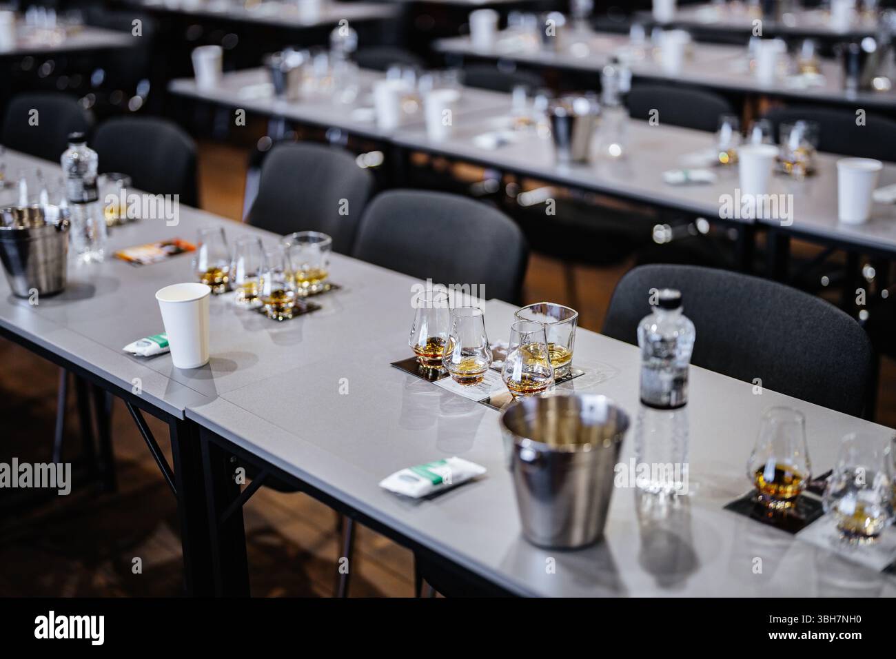Tables set for a whiskey tasting event in a stylish venue Stock Photo ...