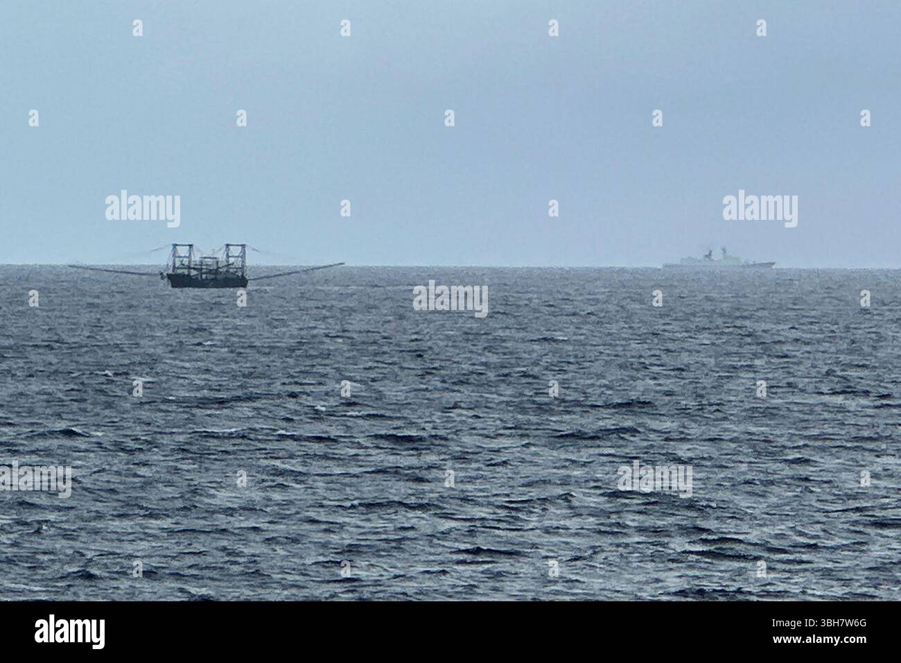 A Chinese navy ship, right, and a Chinese vessel is seen during a ...