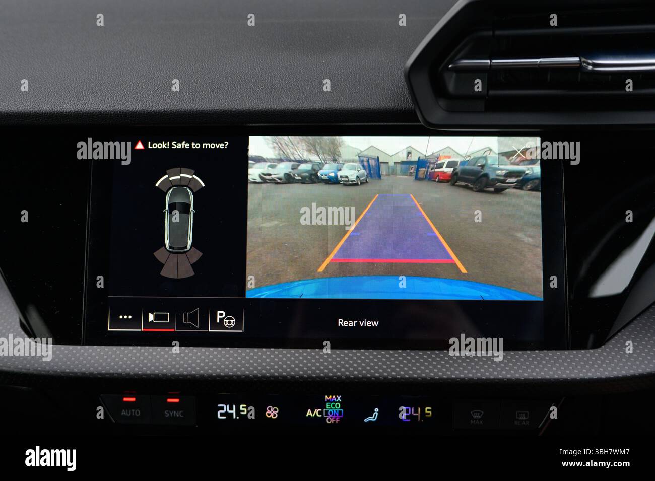 This image shows a cars infotainment screen while parking, featuring ...