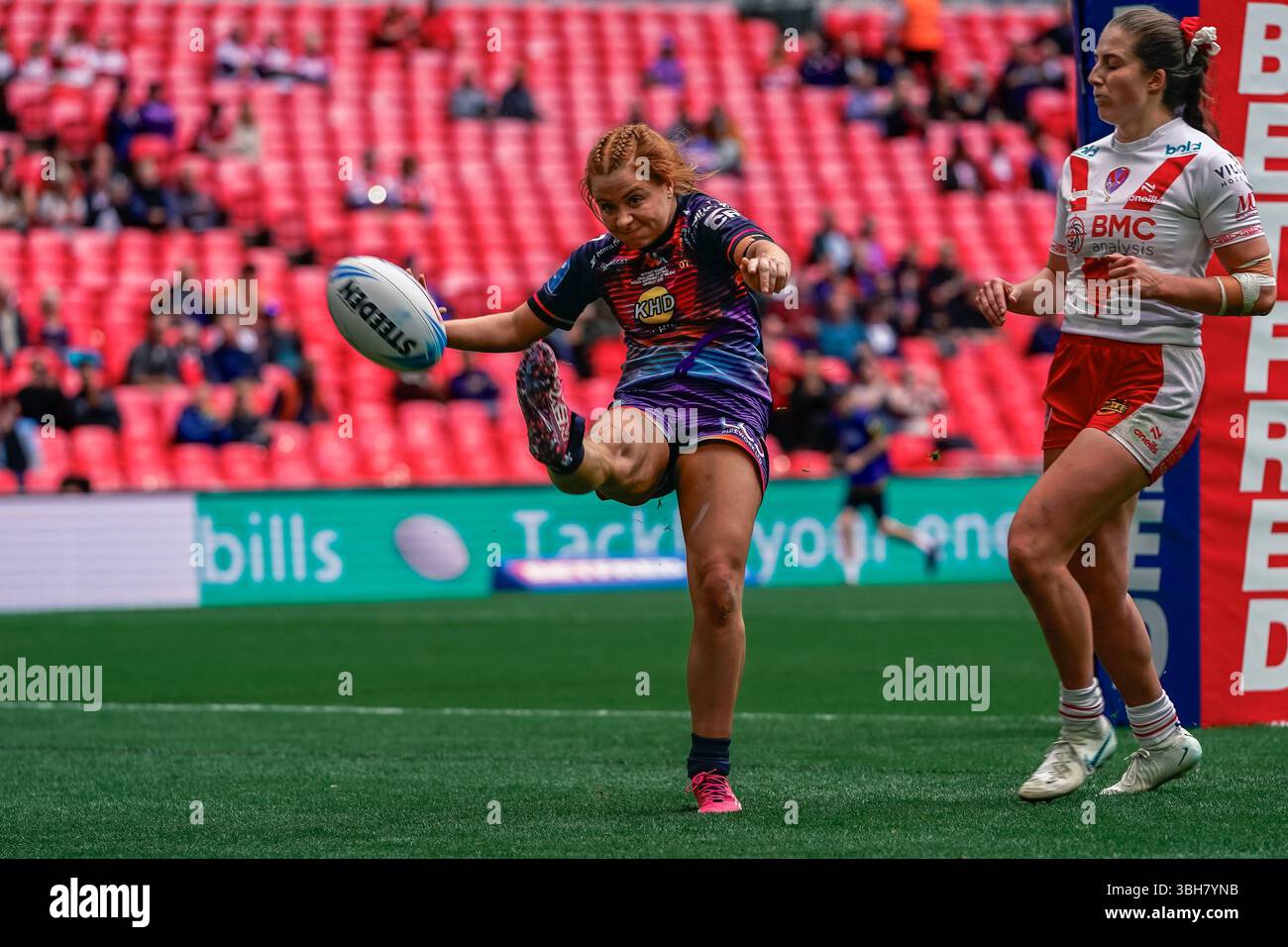 LONDON, ENGLAND - JUNE 7: Grace Banks of Wigan Warrios kicks the ball ...