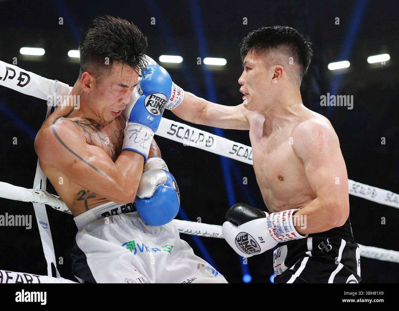 Tomoya Tsuboi, right, of Japan punches Ban Thao Tran, left, of Vietnam ...