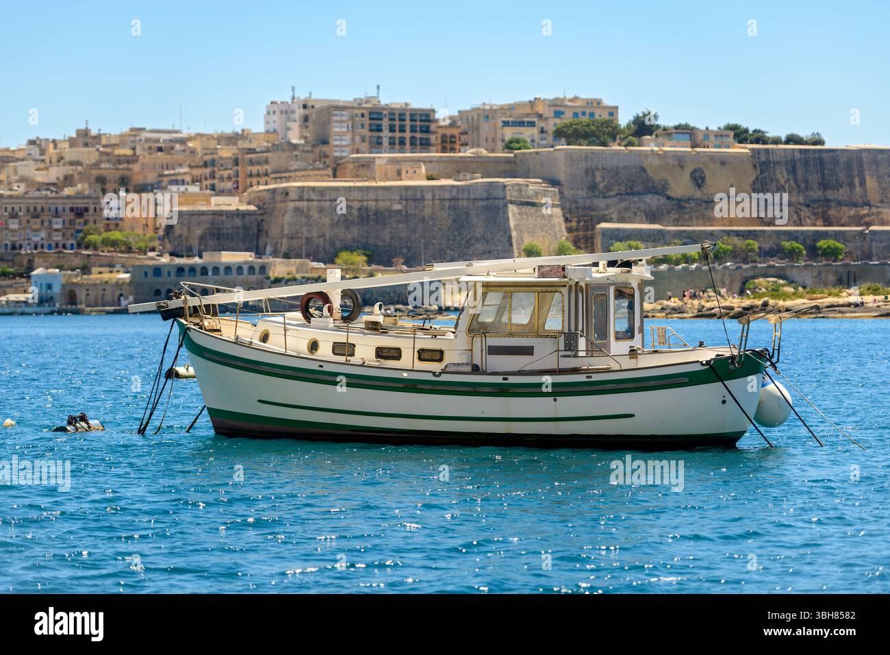 Close-up of an old working boat anchored in calm waters. The vessel ...