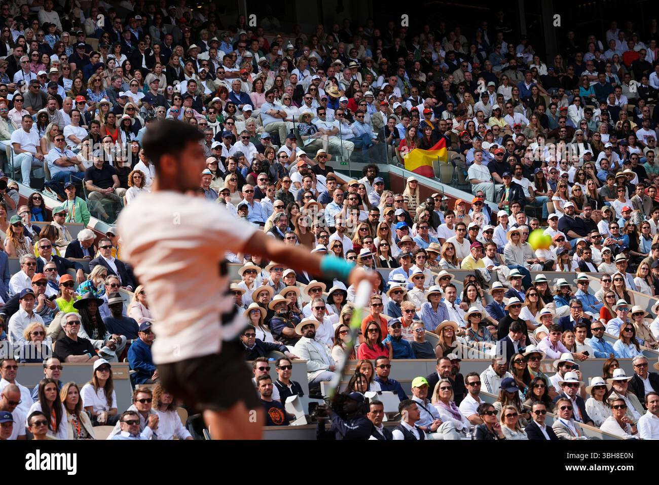 Spectators watch as Spain's Carlos Alcaraz plays a shot against Italy's ...