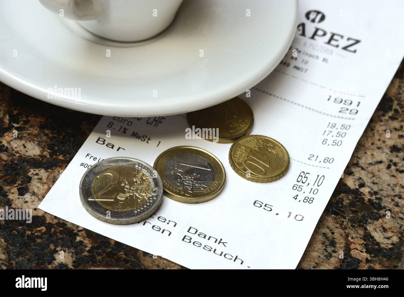 Tip, euro coins with receipt Stock Photo - Alamy