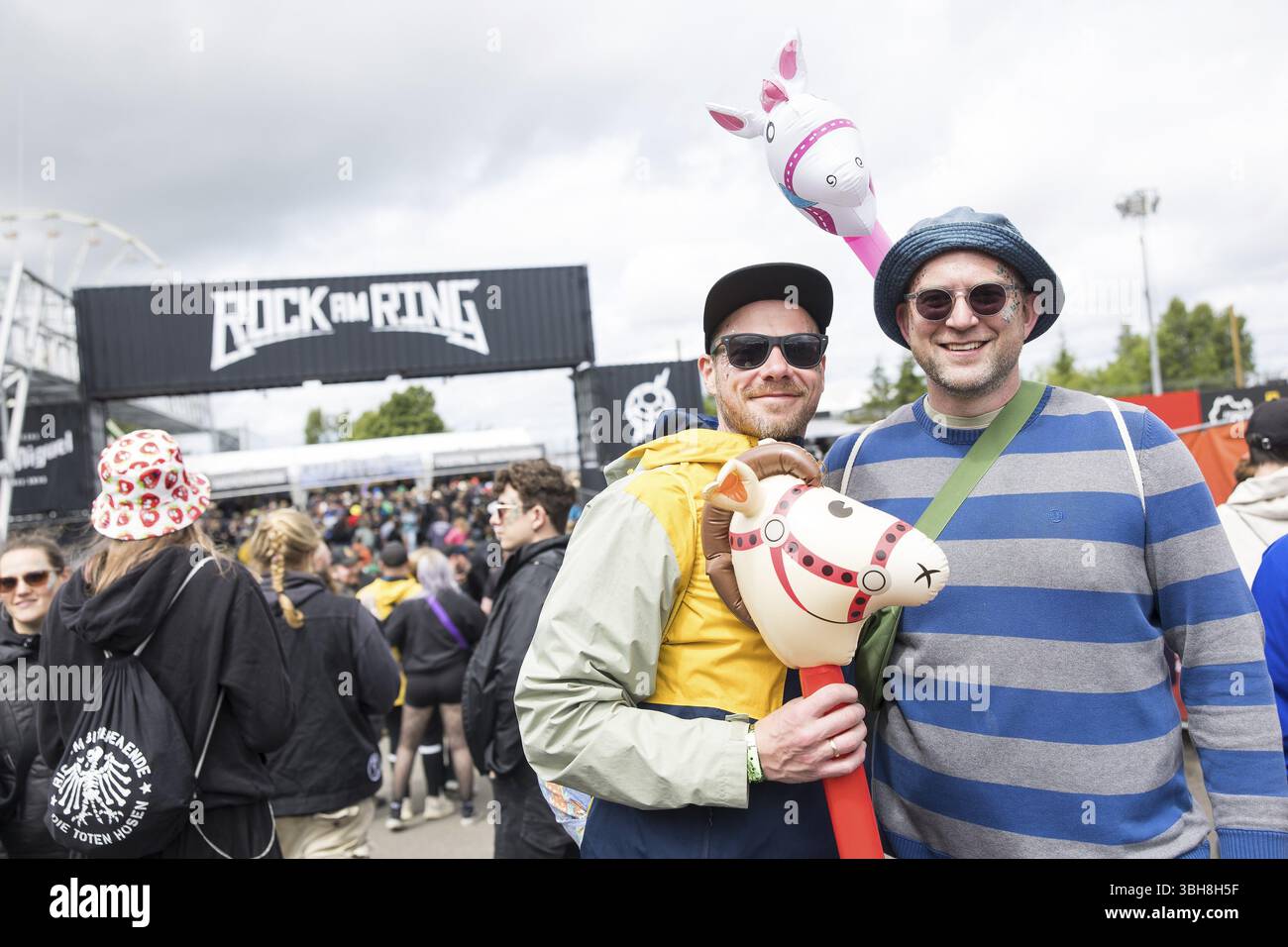 Two festival visitors with their inflatable animals Charles and Chantal ...