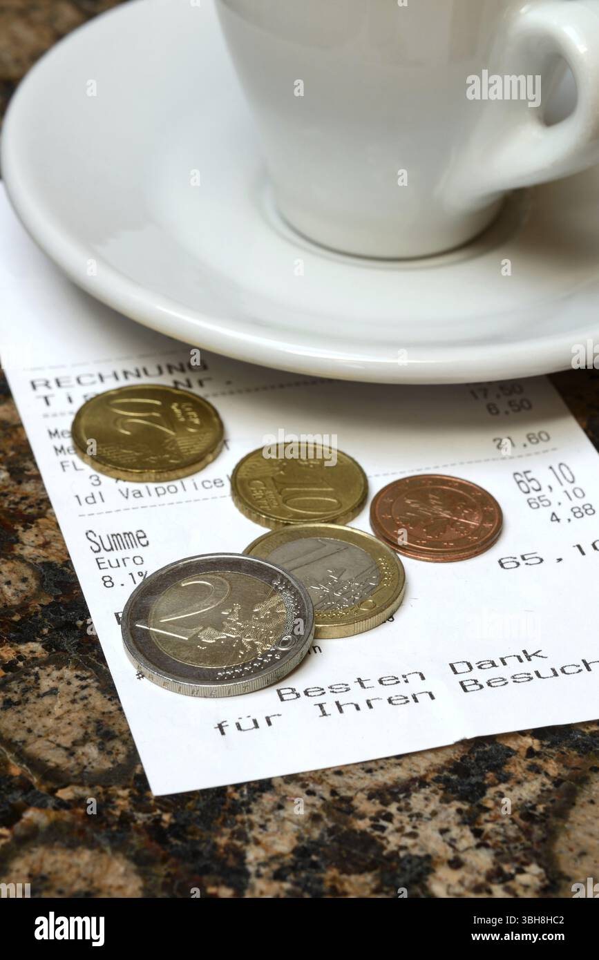 Tip, euro coins with receipt Stock Photo - Alamy