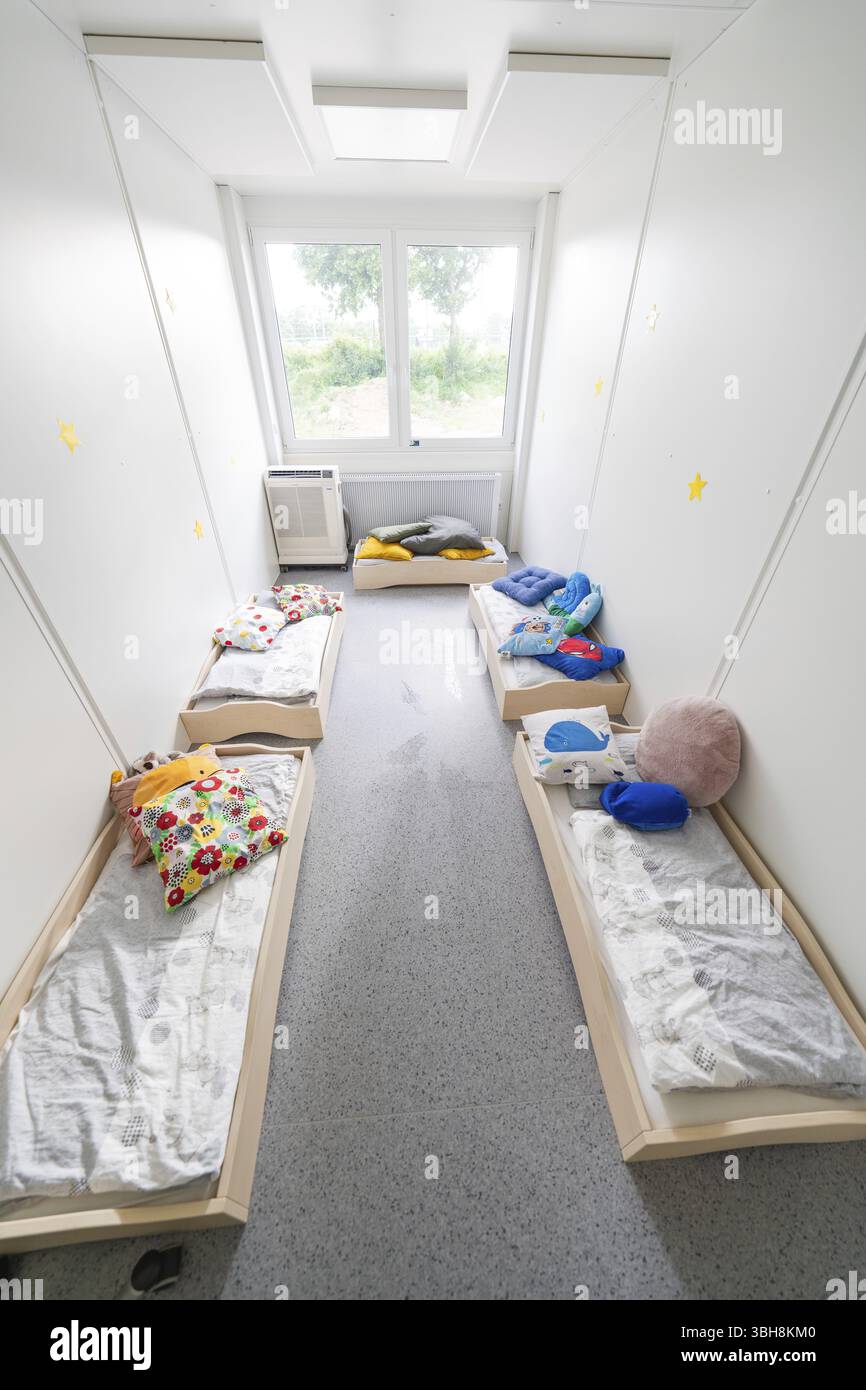 Overview of a dormitory for children with beds, lit by windows ...