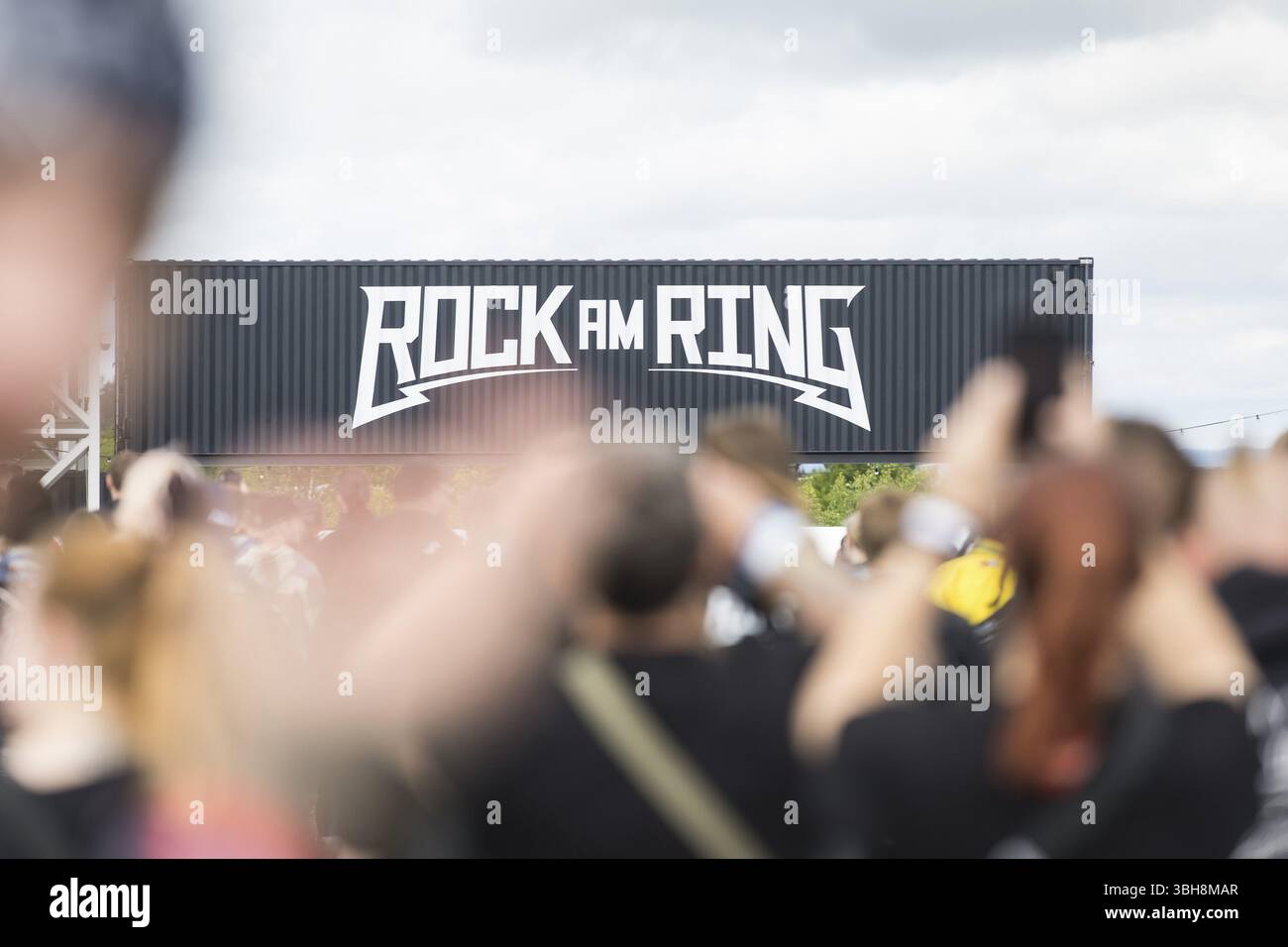 Festival visitors in front of a container with Rock am Ring logo at the ...