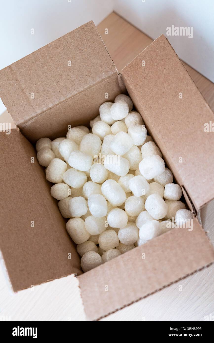 Open cardboard box filled with eco-friendly corn-based packing peanuts ...
