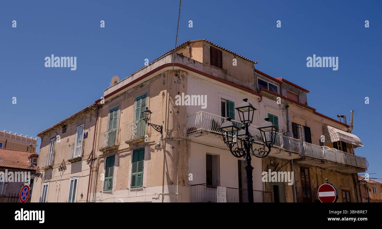 Traditional architecture featuring balconies, green shutters, and a ...