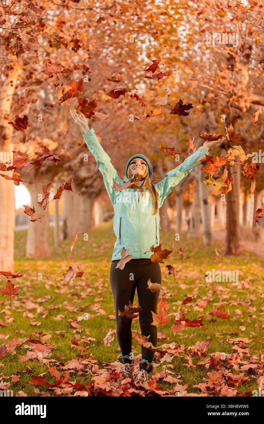 Woman throwing leaves air in hi-res stock photography and images - Alamy
