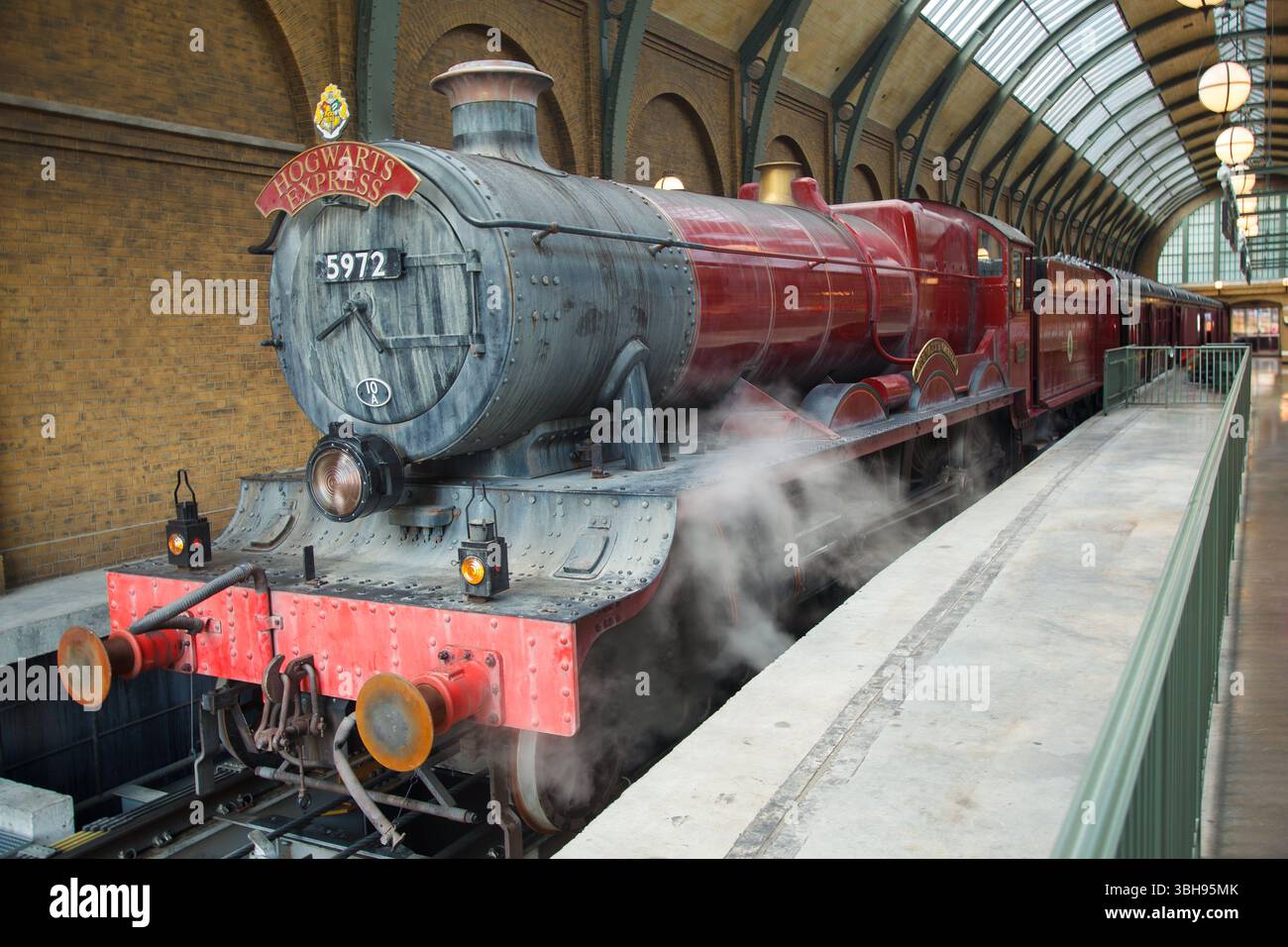 The Hogwarts Express train inside Kings Cross train station in the Wizarding World of Harry ...