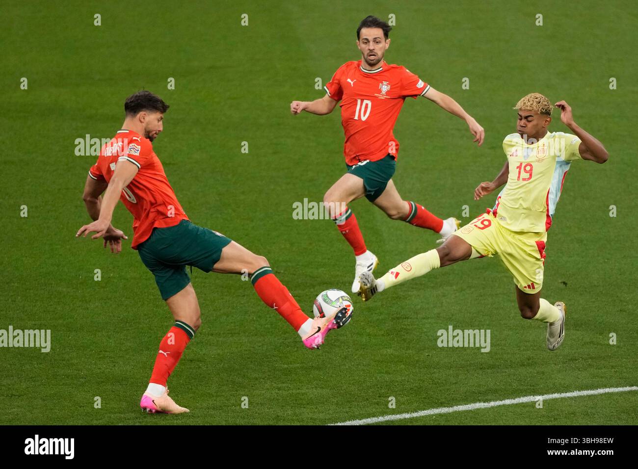 Spain's Lamine Yamal, right, and Portugal's Ruben Dias fight for the ...