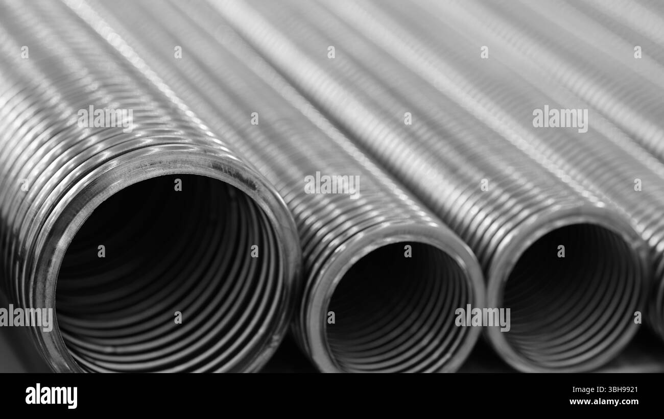 Row of stainless steel corrugated high pressure pipes in silver color ...