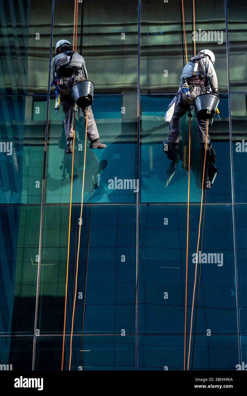 Workers cleaning mirrored windows of a commercial building in São Paulo city, Brazil Stock Photo ...