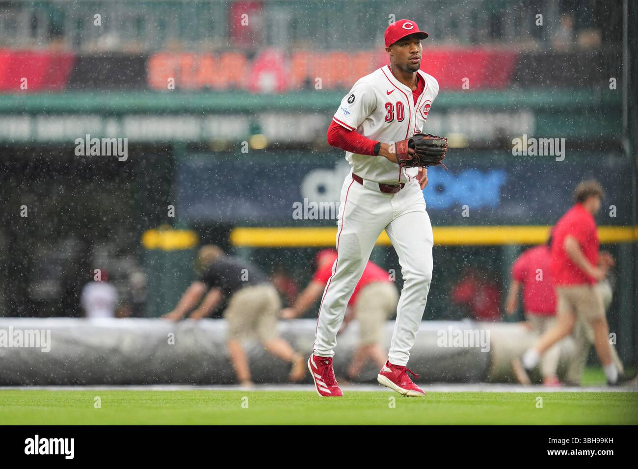Cincinnati Reds' Will Benson (30) jogs to the dugout as the grounds ...