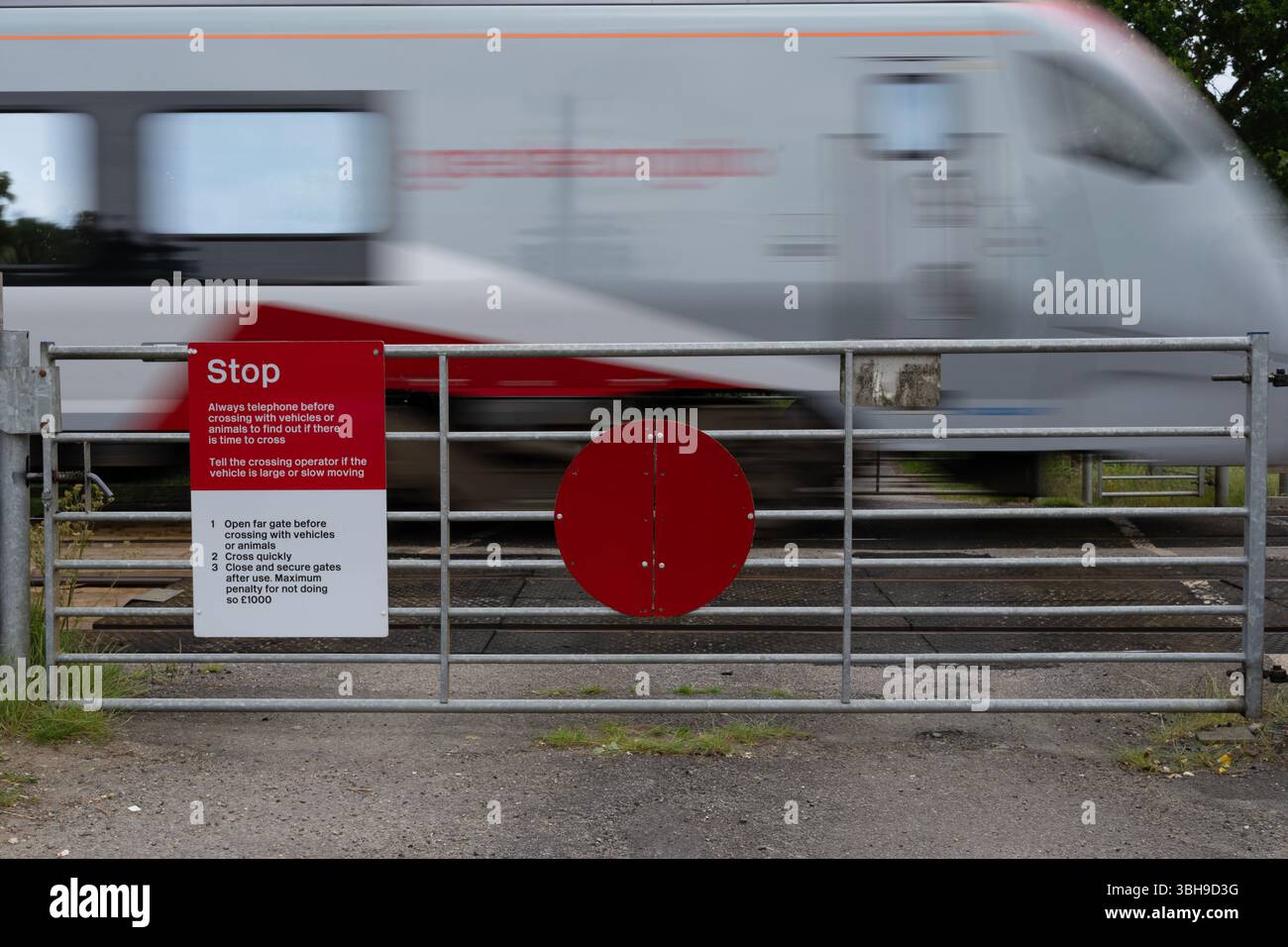 Self operated railway crossing gate Stock Photo - Alamy