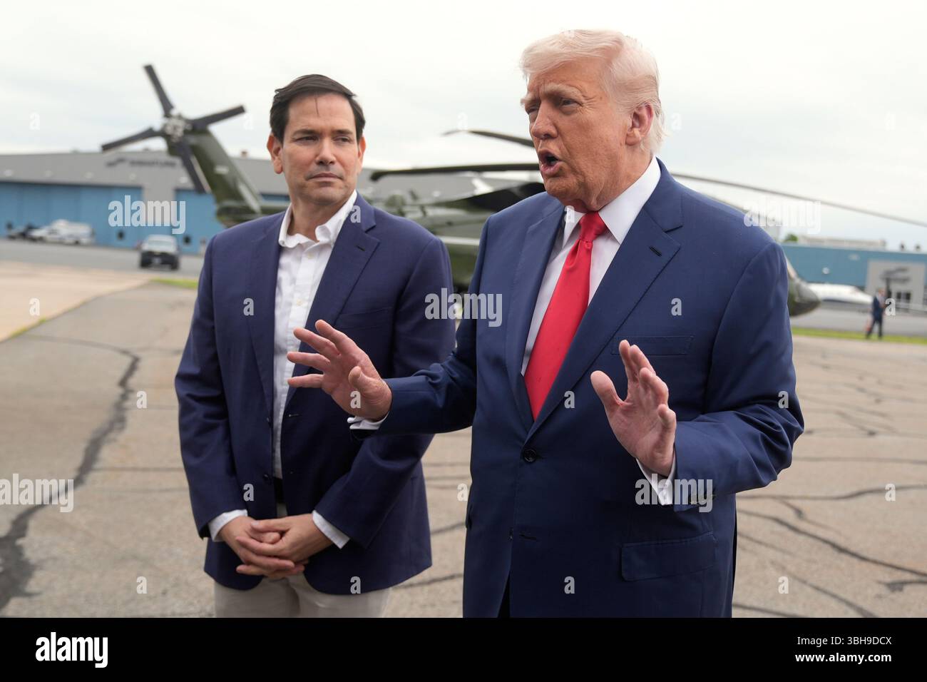 President Donald Trump, right, speaks with reporters as Secretary of ...