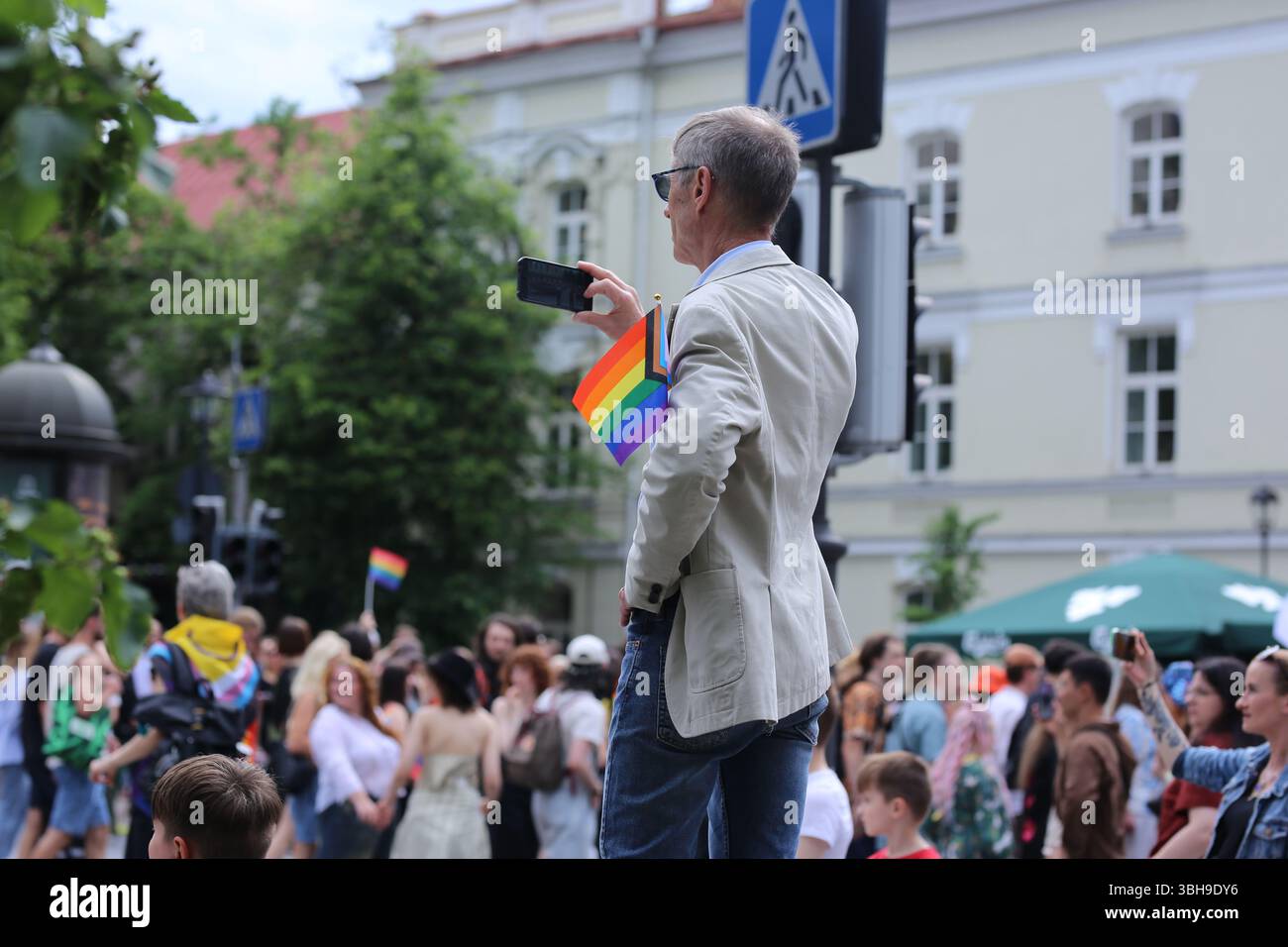 Vilnius, Lithuania - June 7th 2025: A man holding a progress pride flag ...