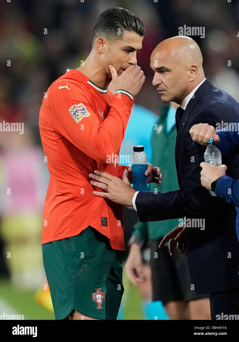 Portugal's Cristiano Ronaldo, left, talks with his coach Roberto ...