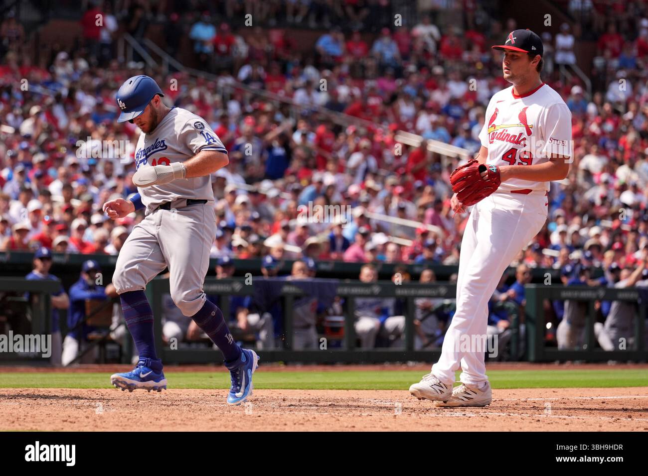 Los Angeles Dodgers' Max Muncy, left, scores on a passed ball as St ...