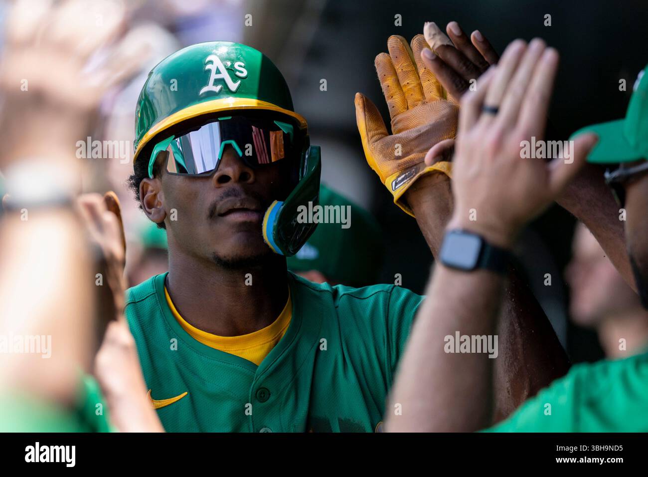 Athletics' Denzel Clarke celebrates in the dugout after scoring during ...