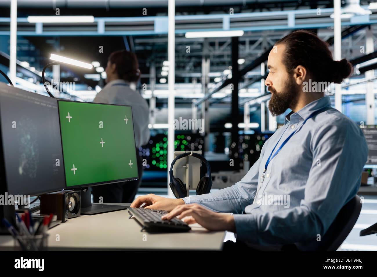 Engineer in data center using green screen mockup PC to update storage arrays software ...