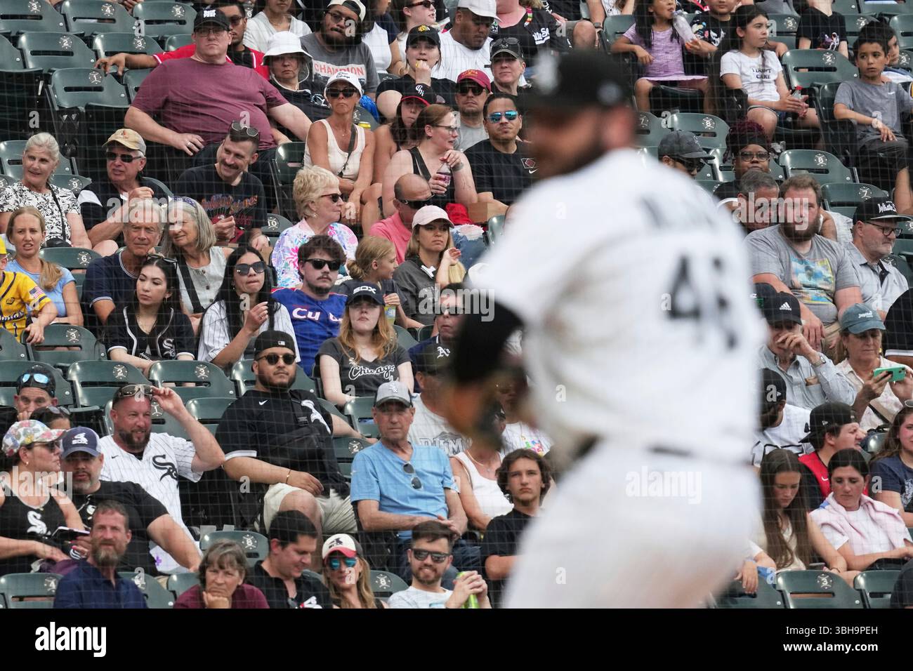 Fans watch Chicago White Sox relief pitcher Bryse Wilson during the ...