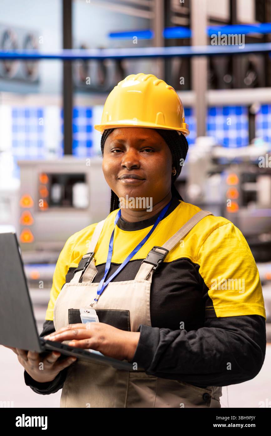 African american technician overseeing production line in smart ...